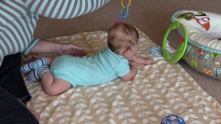 Pathways.org | While lying on tummy, pushes up on arms