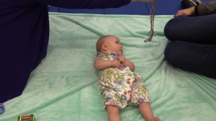 Pathways.org | While lying on back, visually tracks a moving toy from side to side